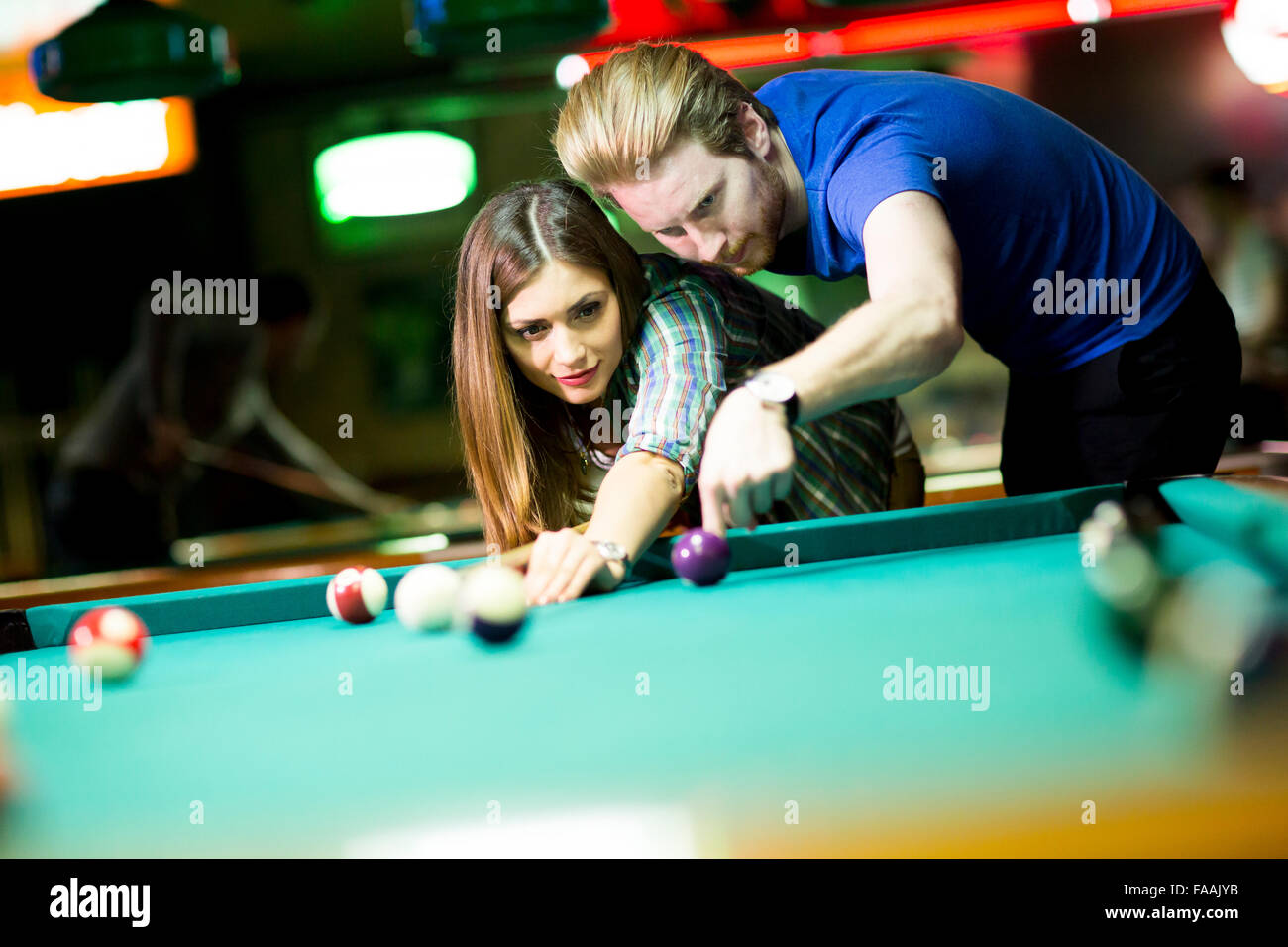 Young people playing pool Stock Photo - Alamy
