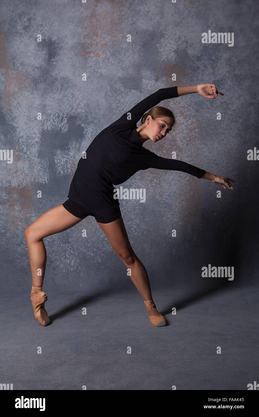 Young beautiful modern style dancer posing on a studio background Stock ...