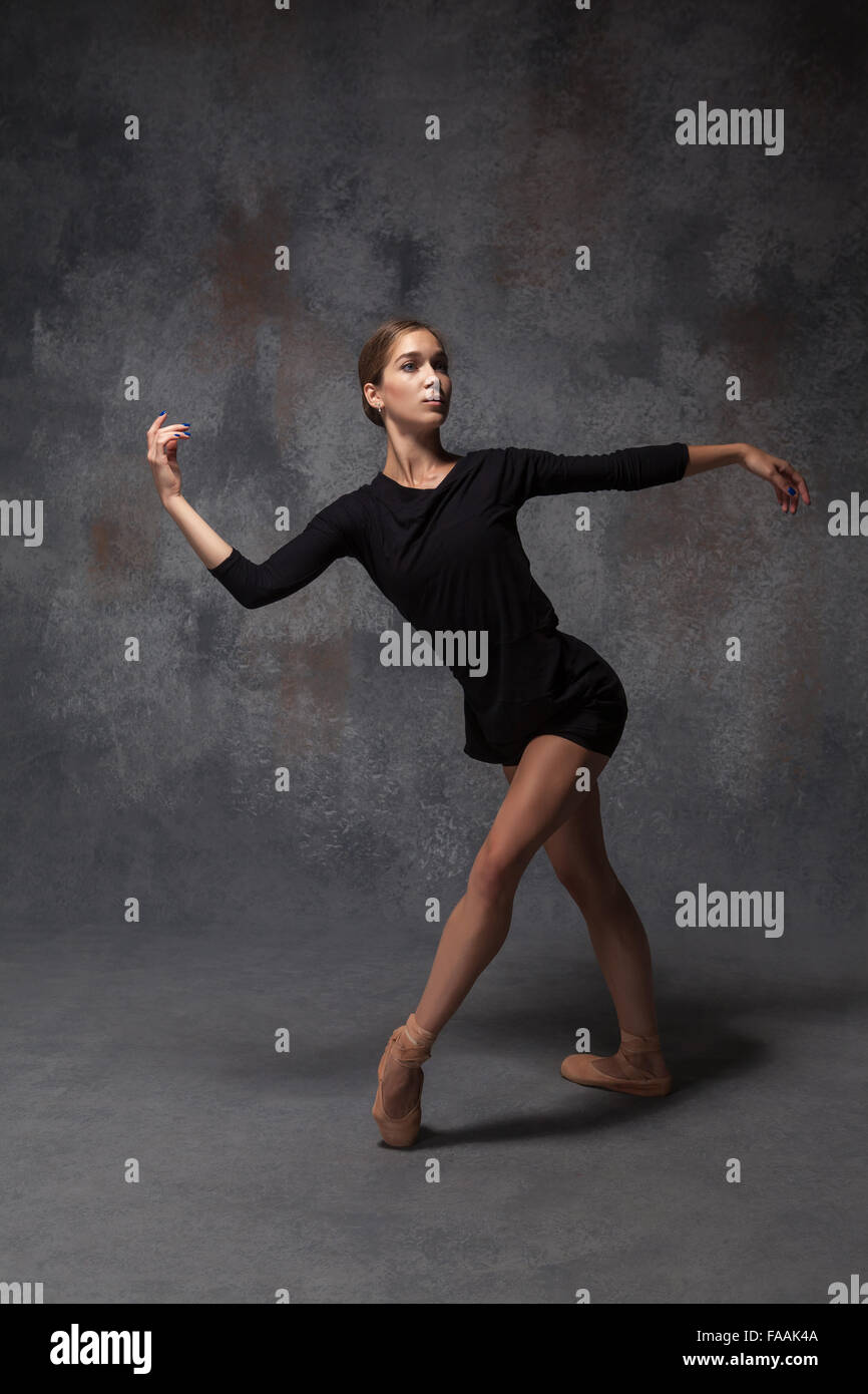 Young beautiful modern style dancer posing on a studio background Stock ...