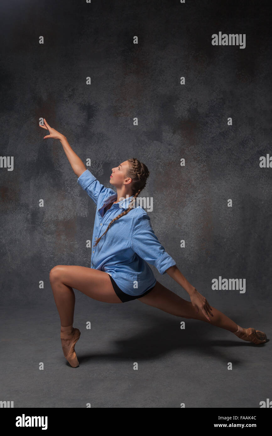Young beautiful modern style dancer posing on a studio background Stock ...