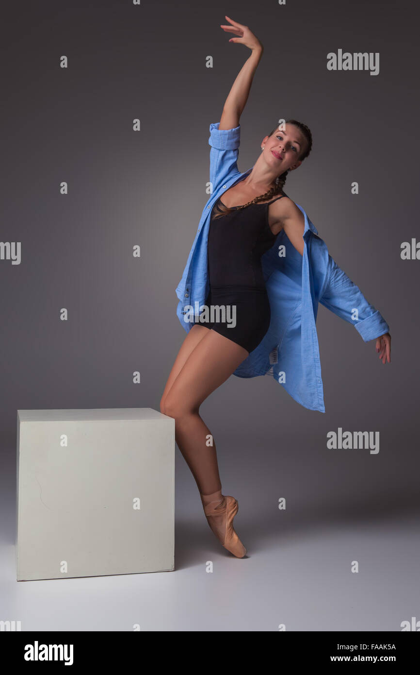 Young beautiful modern style dancer posing on a studio background Stock ...