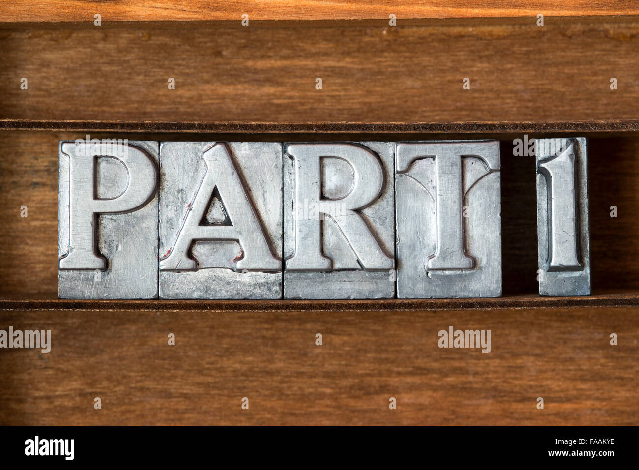 part 1 phrase made from metallic letterpress type on wooden tray Stock ...