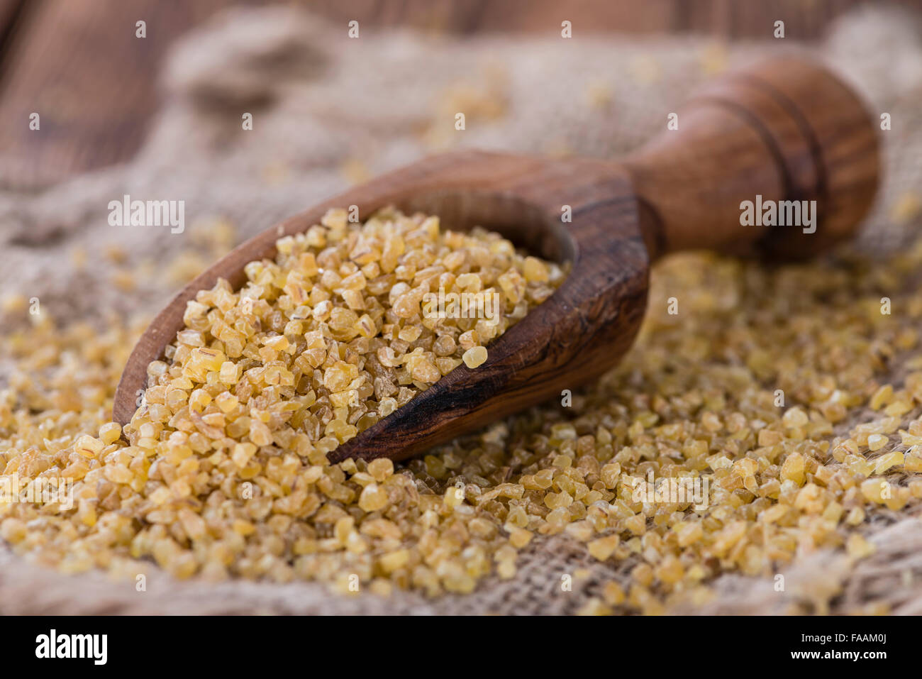Portion of raw Bulgur (close-up shot) on wooden background Stock Photo ...