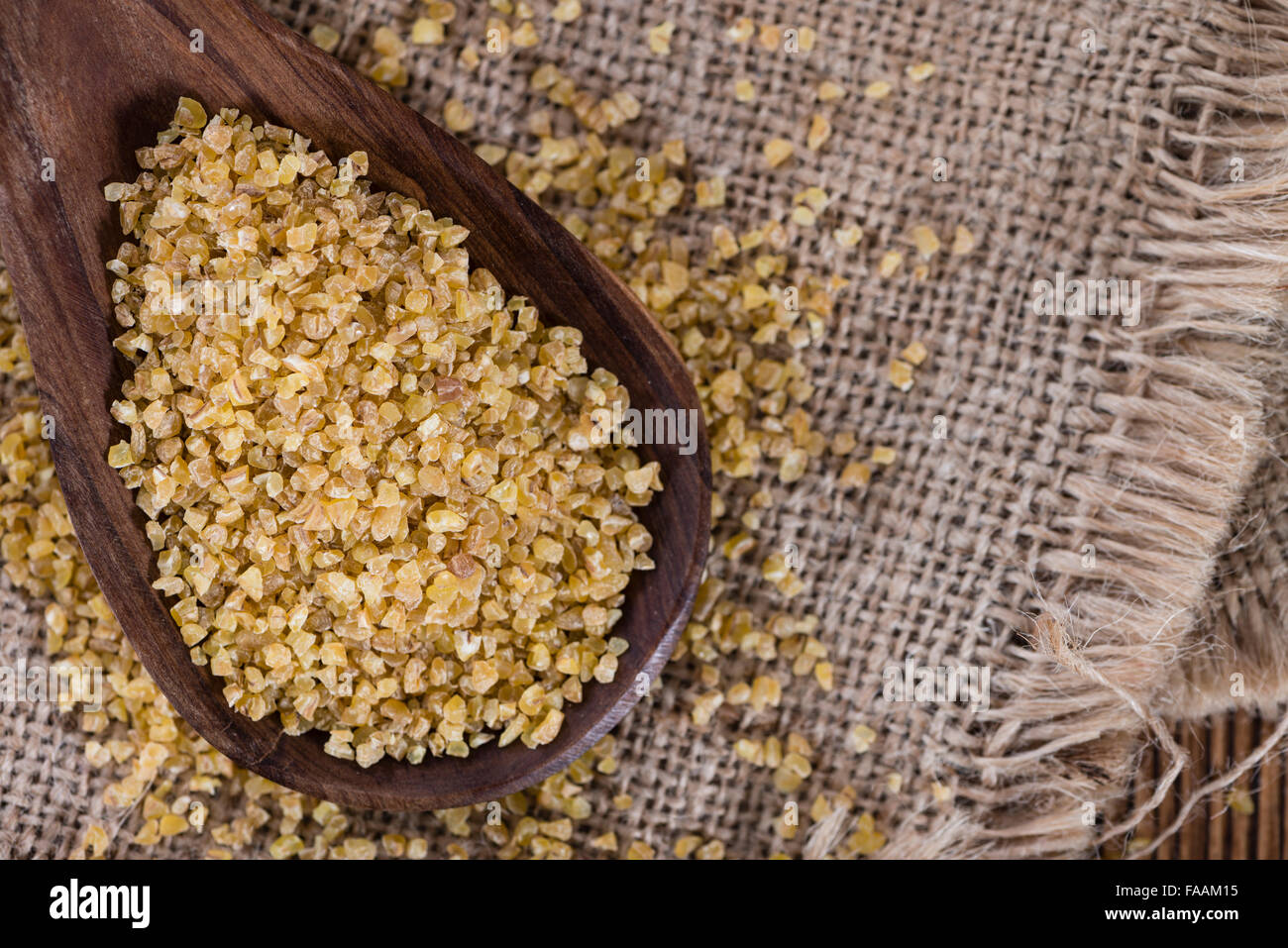 Portion of raw Bulgur (close-up shot) on wooden background Stock Photo ...