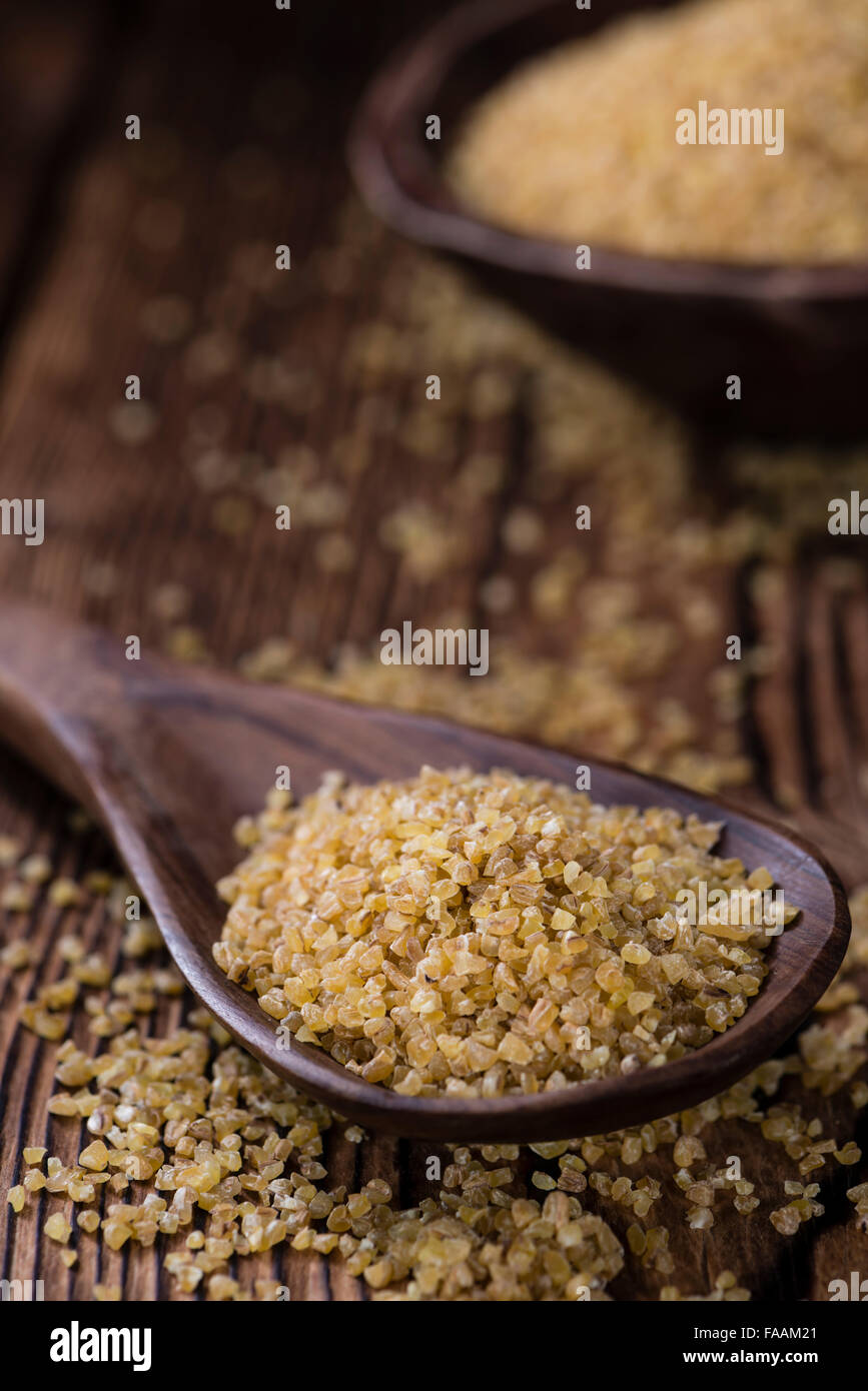 Portion of raw Bulgur (close-up shot) on wooden background Stock Photo ...