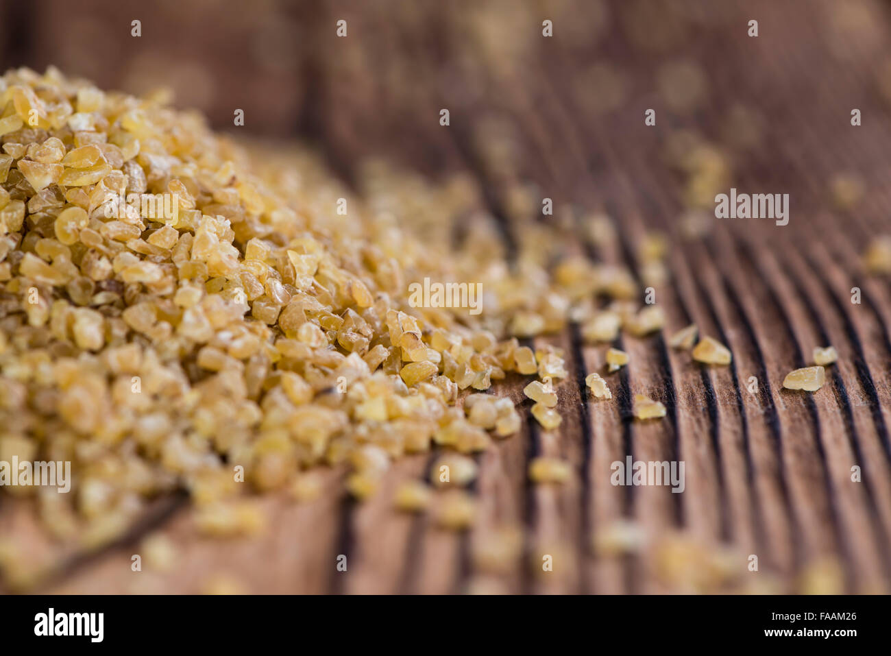 Raw Bulgur (on wooden background) as detailed close-up shot Stock Photo ...
