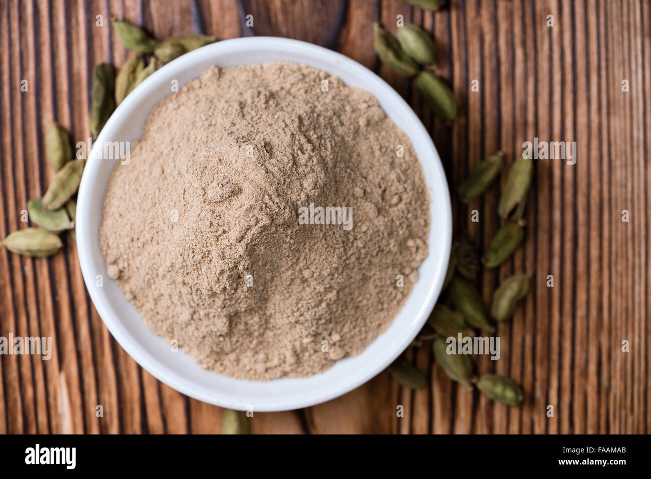 Portion of Cardamon Powder (close-up shot) on wooden background Stock ...