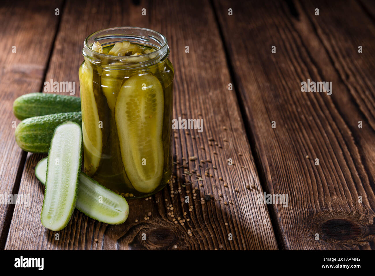 Sliced Cucumbers (pickled) on vintage wooden background (close-up shot ...