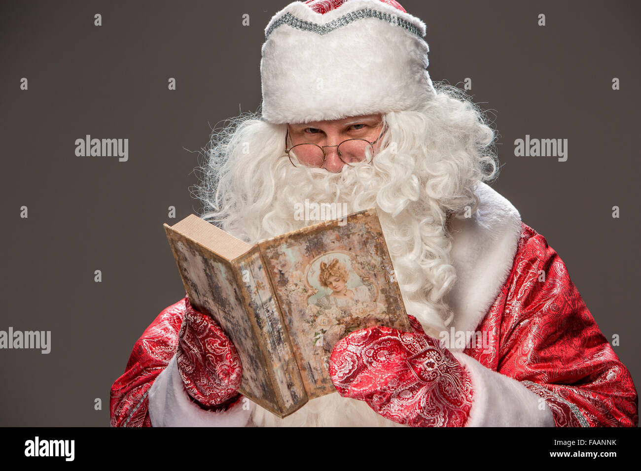 Santa Claus reading book Stock Photo - Alamy