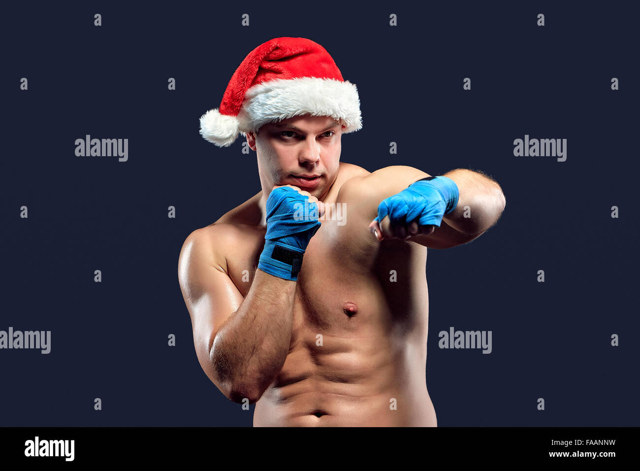 Christmas fitness boxer wearing santa hat boxing on black Stock Photo ...
