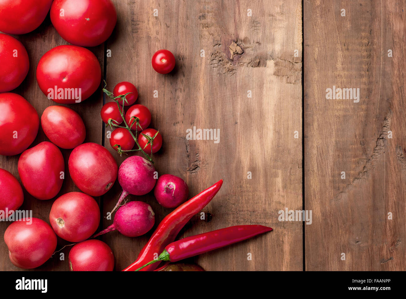 The red vegetables on wooden table Stock Photo - Alamy