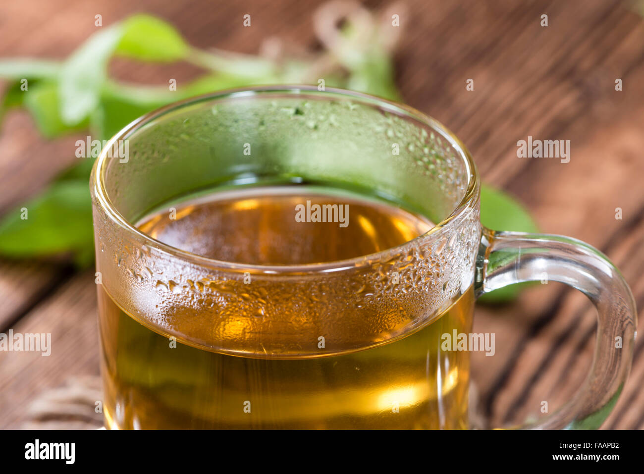Fresh made Sage Tea (on vintage wooden background) as detailed close-up ...