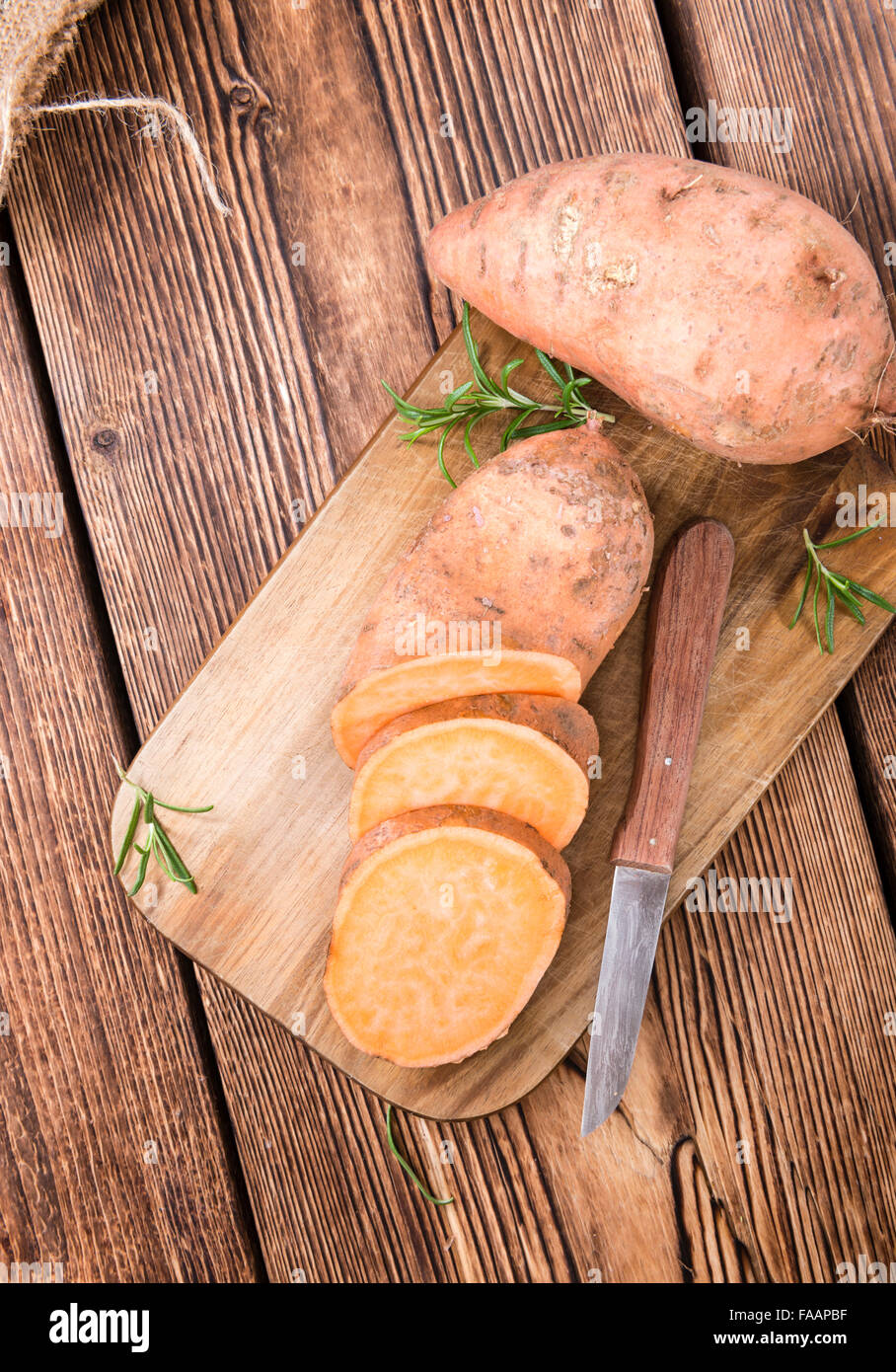 Sweet Potato (close-up shot) on rustic wooden background Stock Photo ...