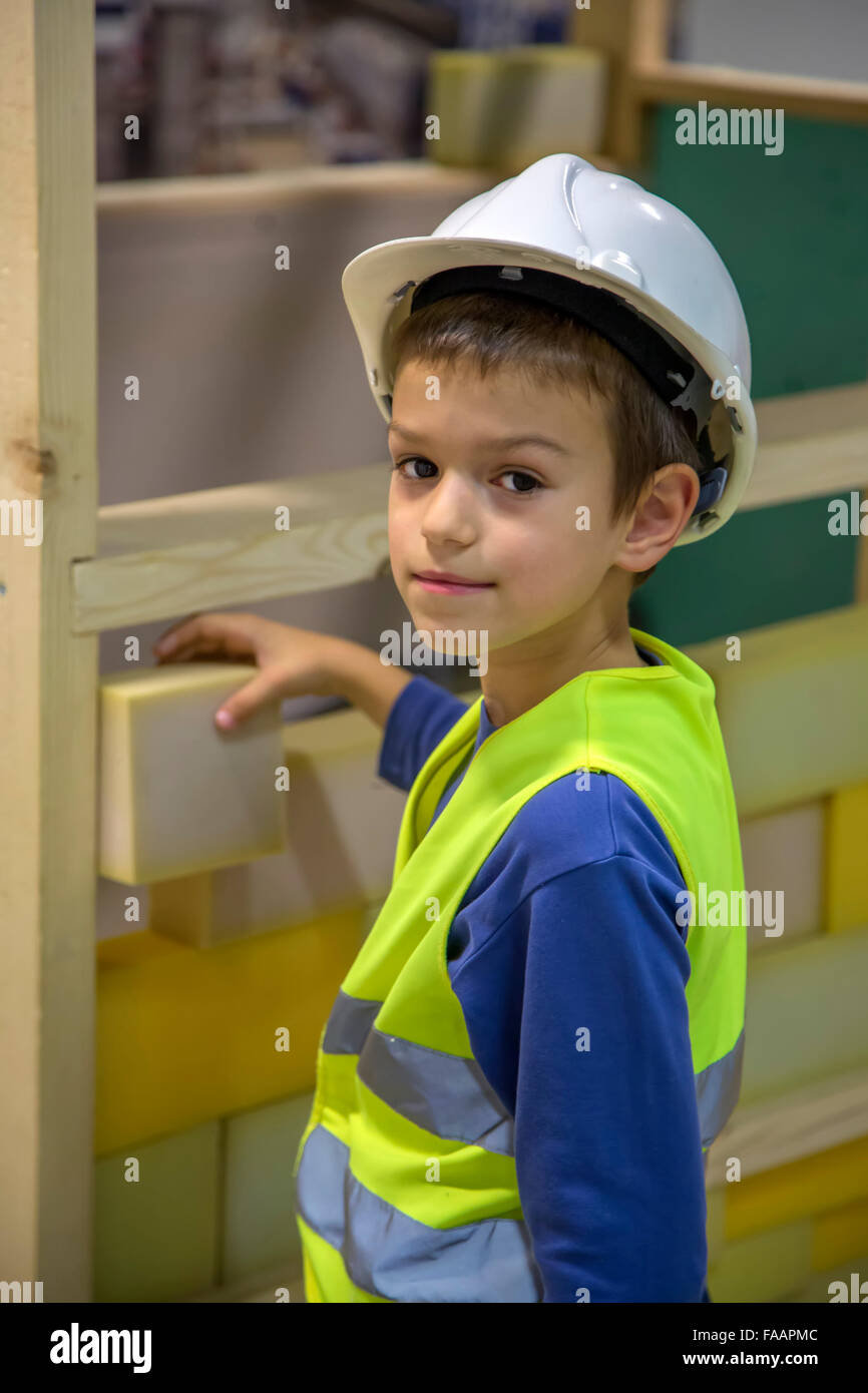 Boy builds a house at playground Stock Photo - Alamy