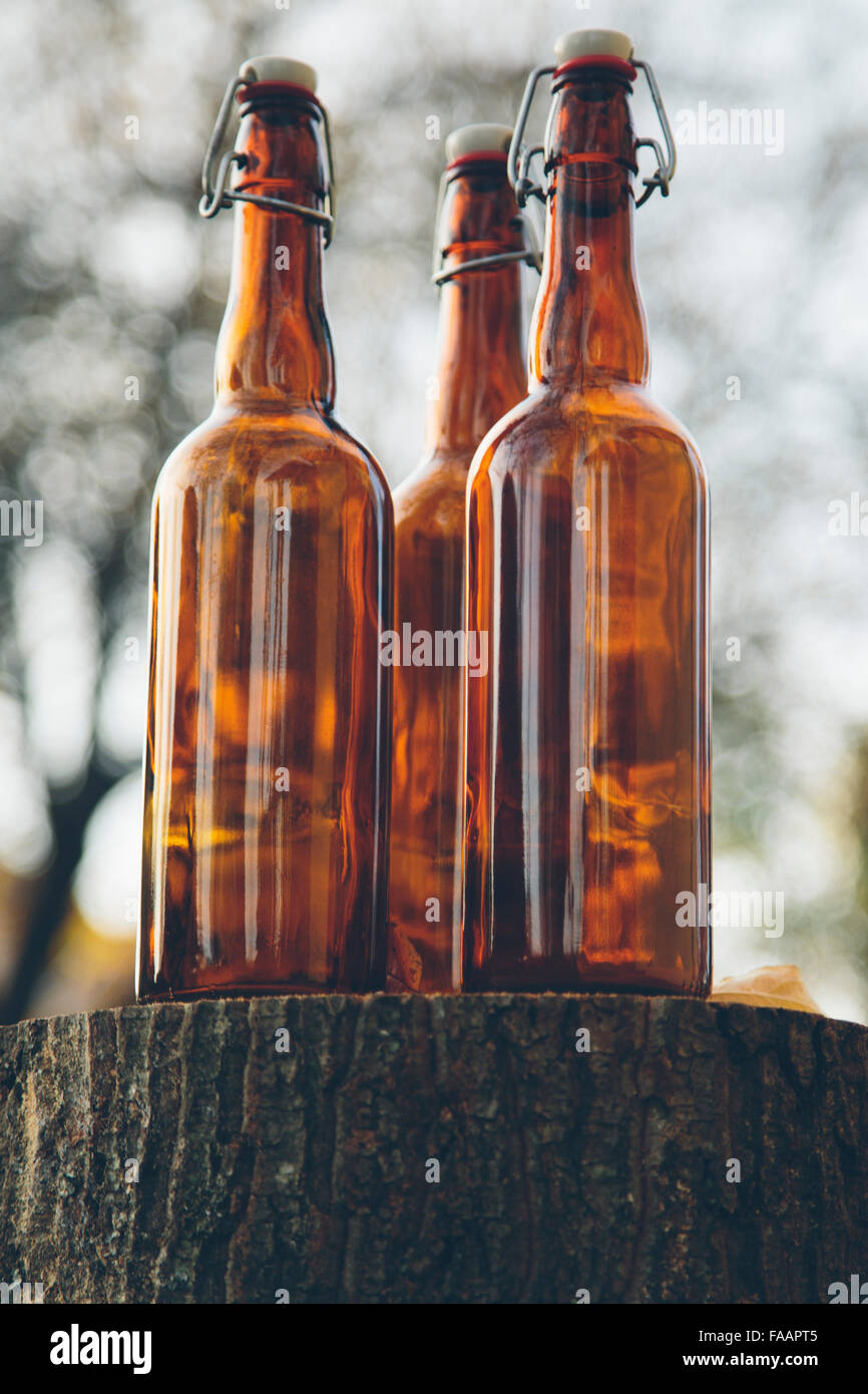 Glass bottles on wooden stack Stock Photo - Alamy
