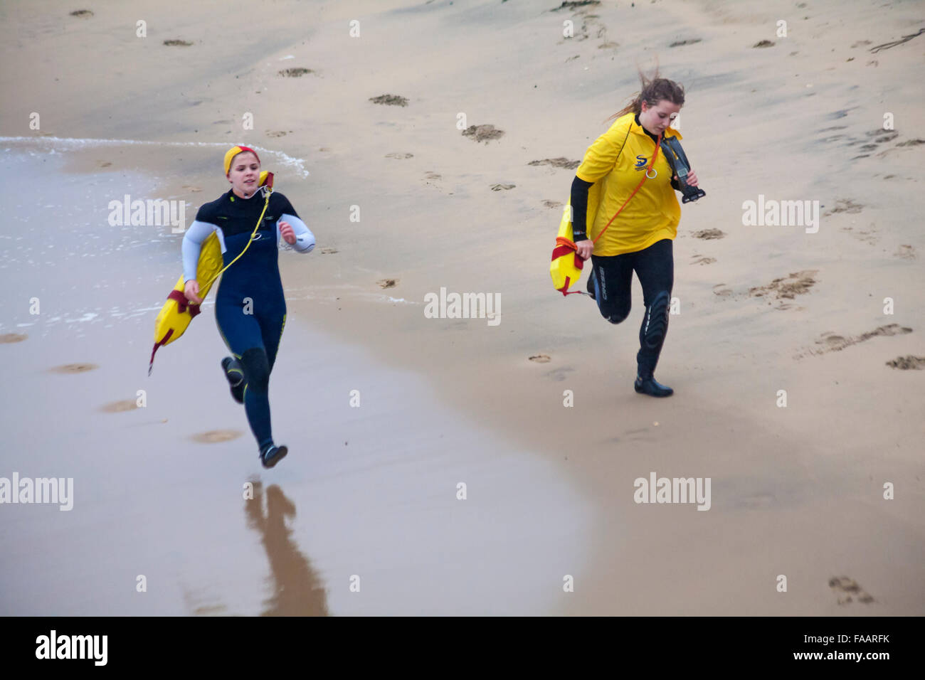 Rnli lifeguards running along seashore hi-res stock photography and ...