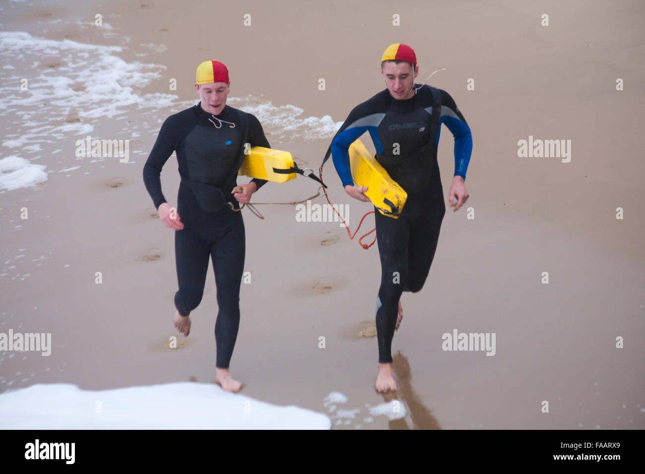Rnli lifeguards running along seashore hi-res stock photography and ...