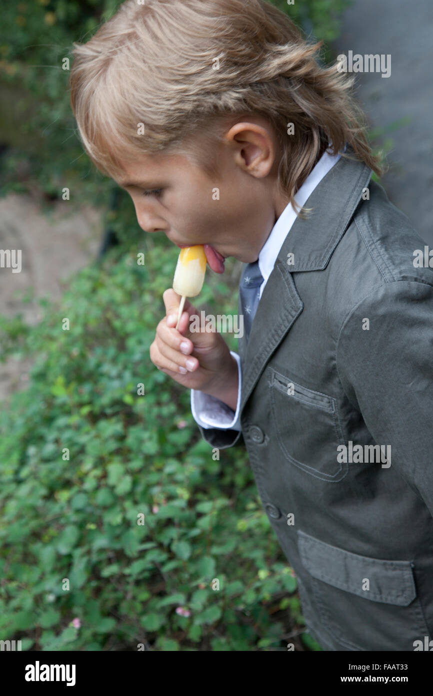 Boy eating ice cream walking hi-res stock photography and images - Alamy
