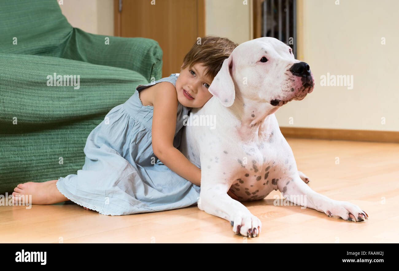 Happy female toddler on the floor with dogo Argentino Stock Photo - Alamy