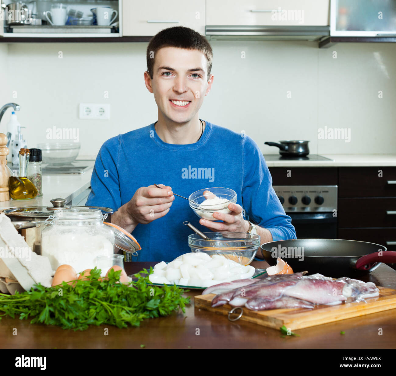 boy preparing batter for cooking calamari rings Stock Photo - Alamy