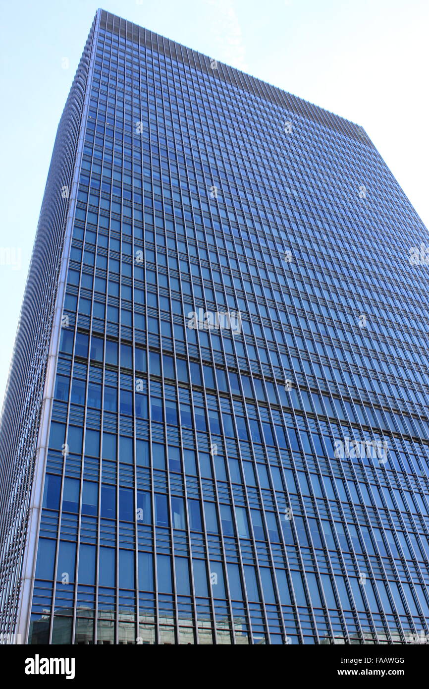 Modern glass skyscraper on a blue sky background Stock Photo - Alamy