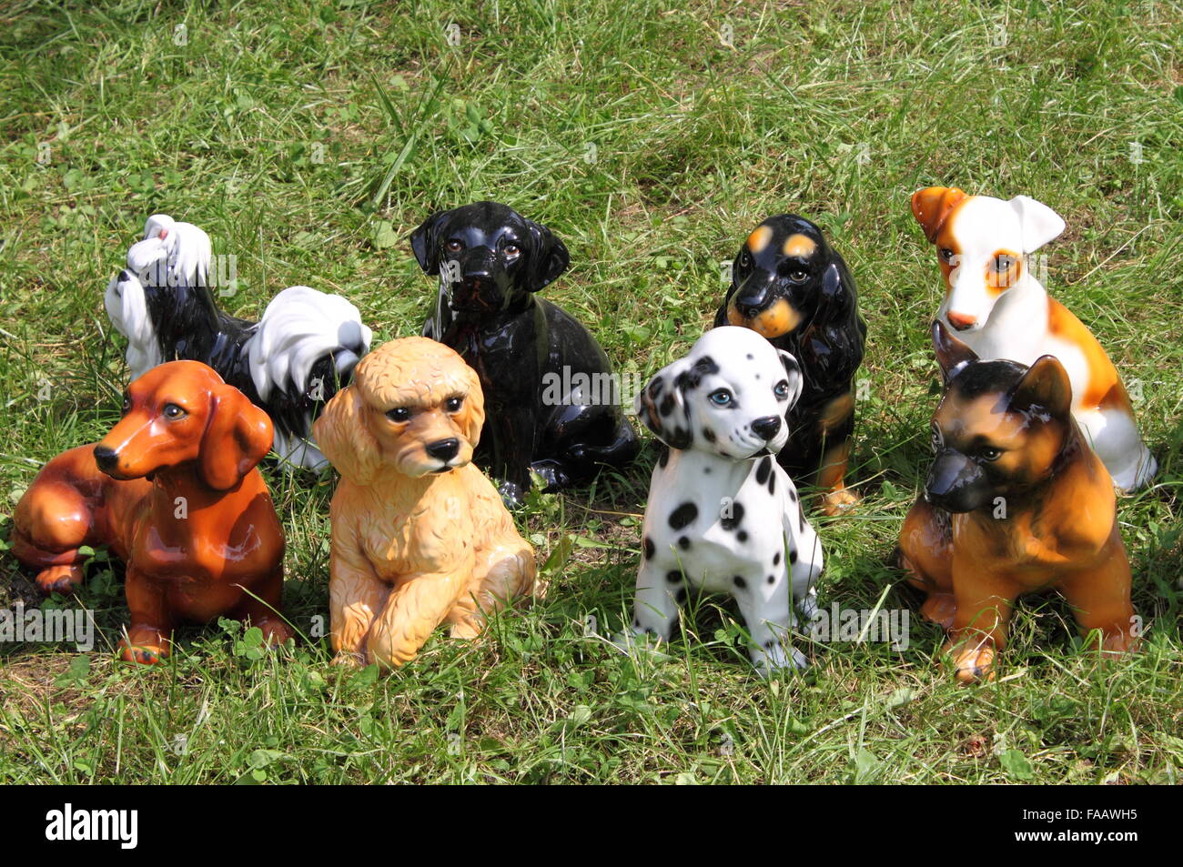 Dog breed statues on a grass background Stock Photo - Alamy