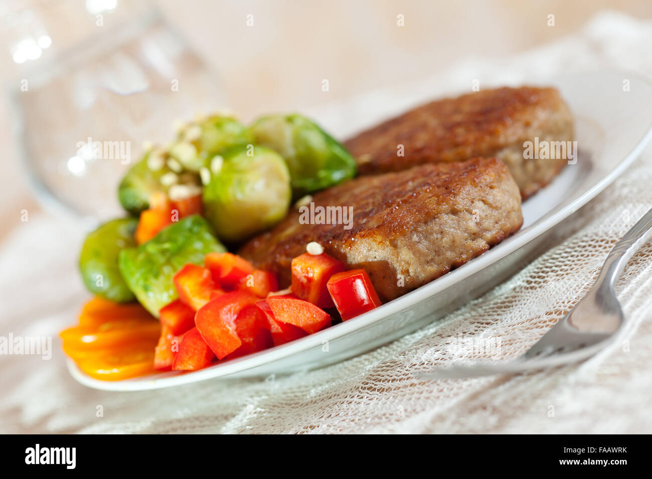 Fast food. Grilled meat cutlets with vegetables Stock Photo - Alamy