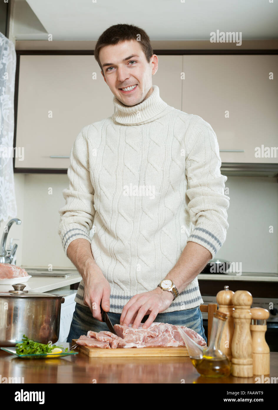 Guy cooking french-style meat. Hands cutting raw meat Stock Photo - Alamy