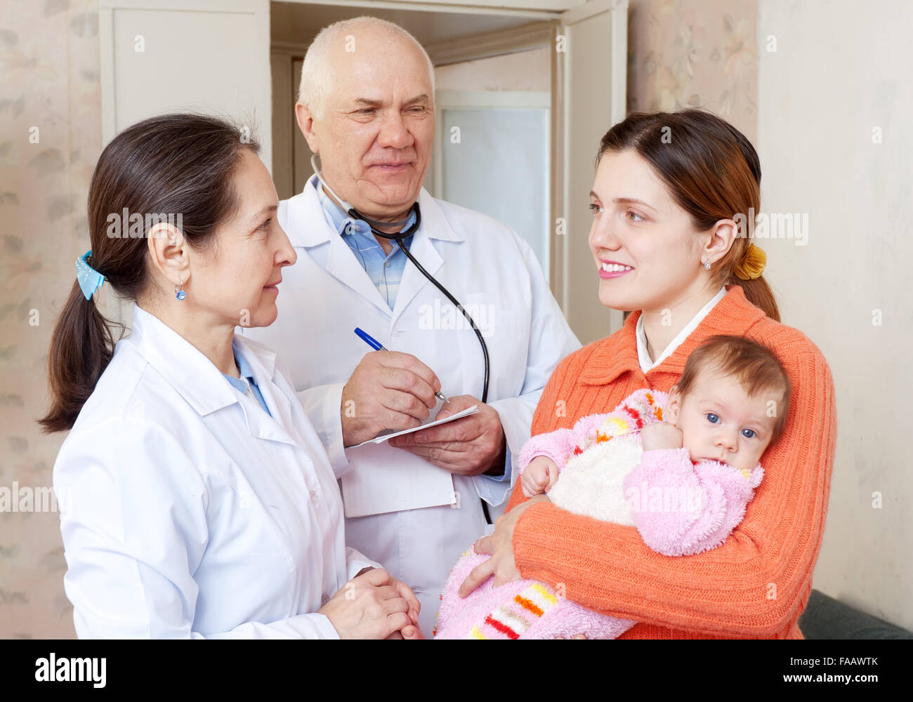 woman with baby in arms and mature pediatrician doctors Stock Photo - Alamy