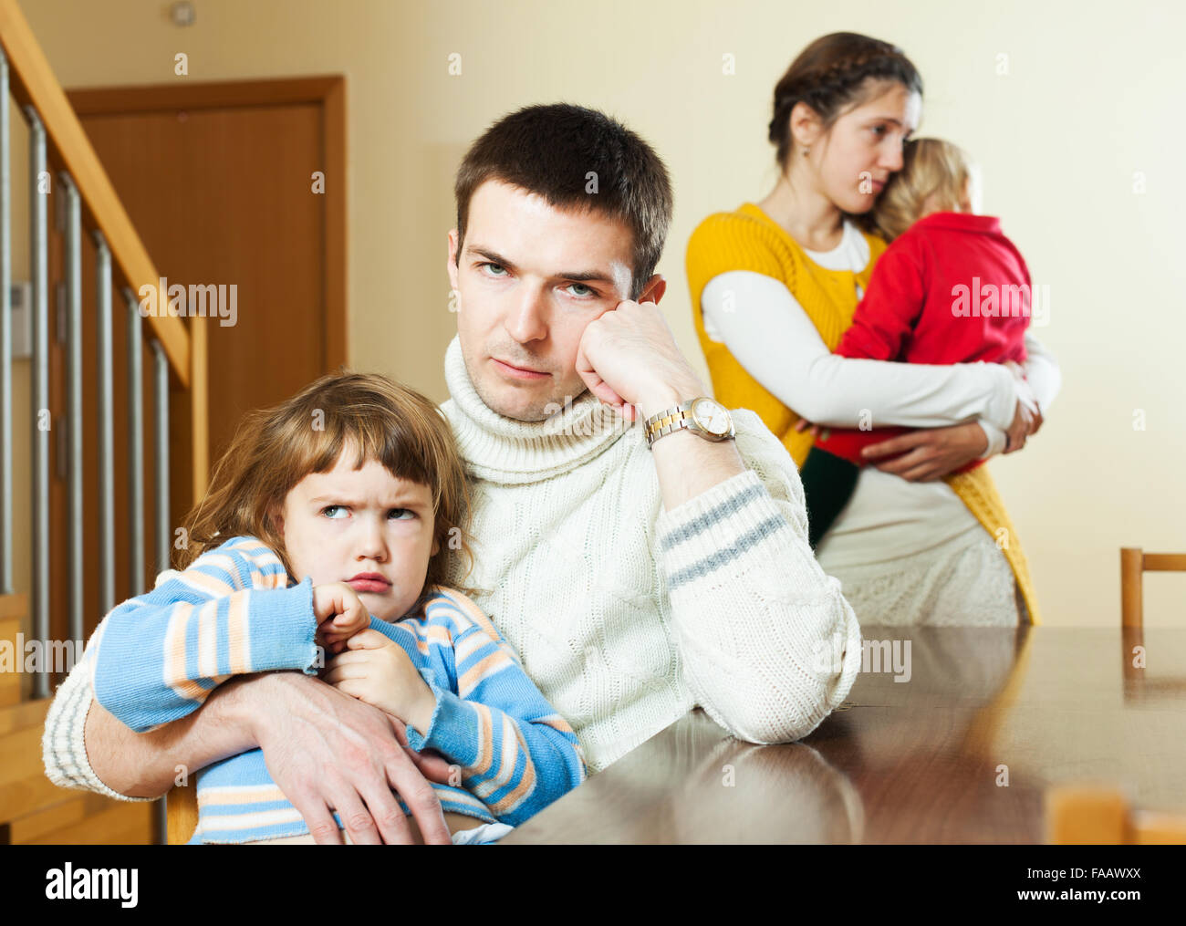 Young couple with two children in quarrel Stock Photo - Alamy