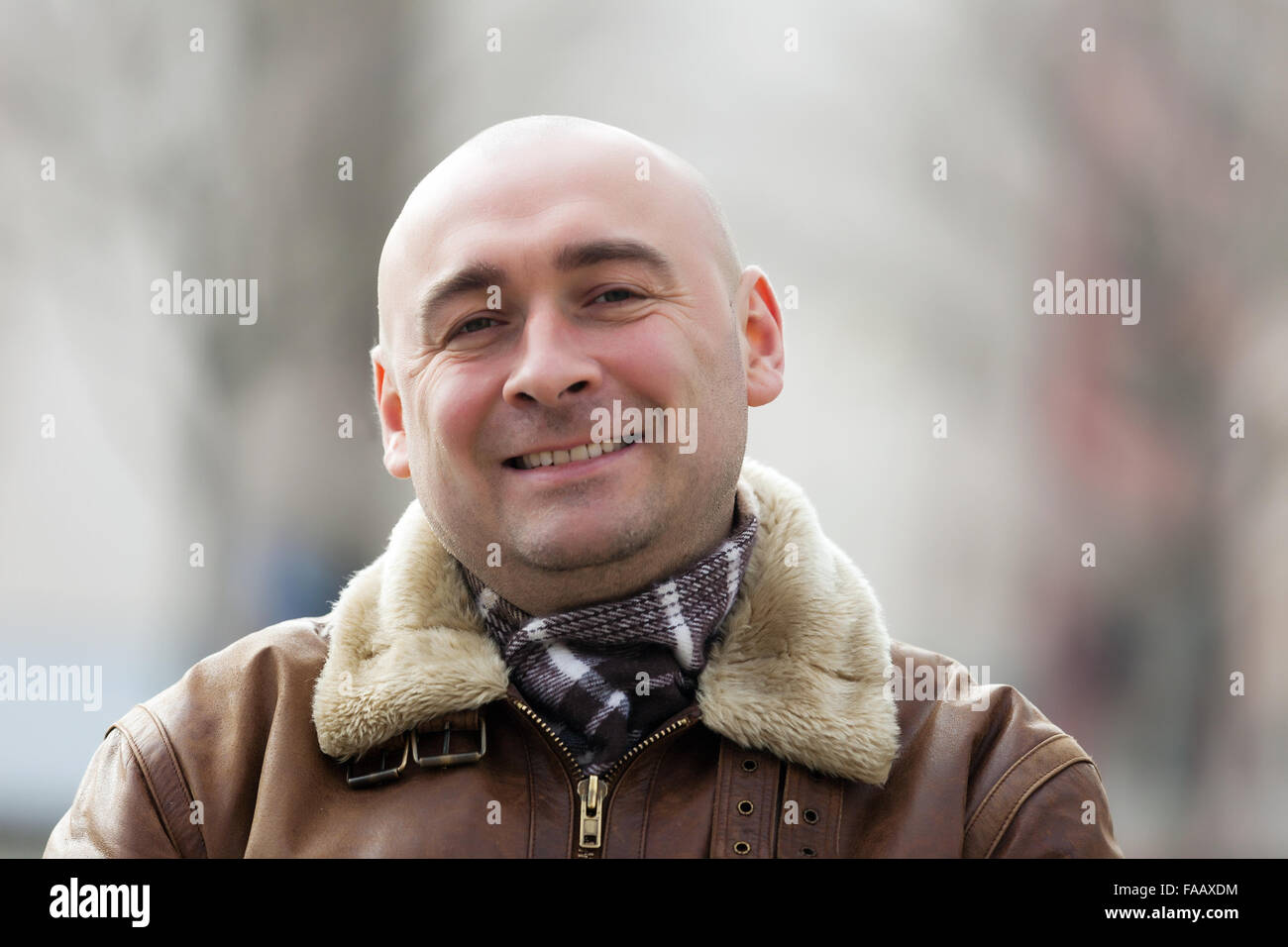 Portrait of smiling guy at city street in autumn Stock Photo - Alamy