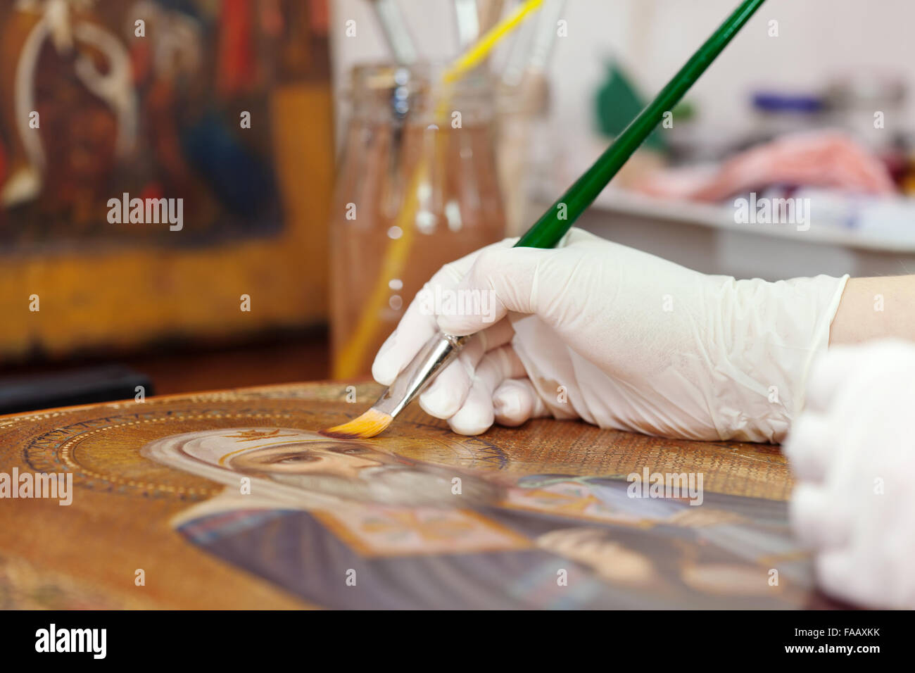 The artist works on the icon in the icon-painting workshop Stock Photo ...