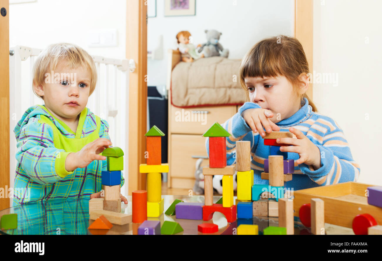 serious children playing with wooden blocks Stock Photo - Alamy