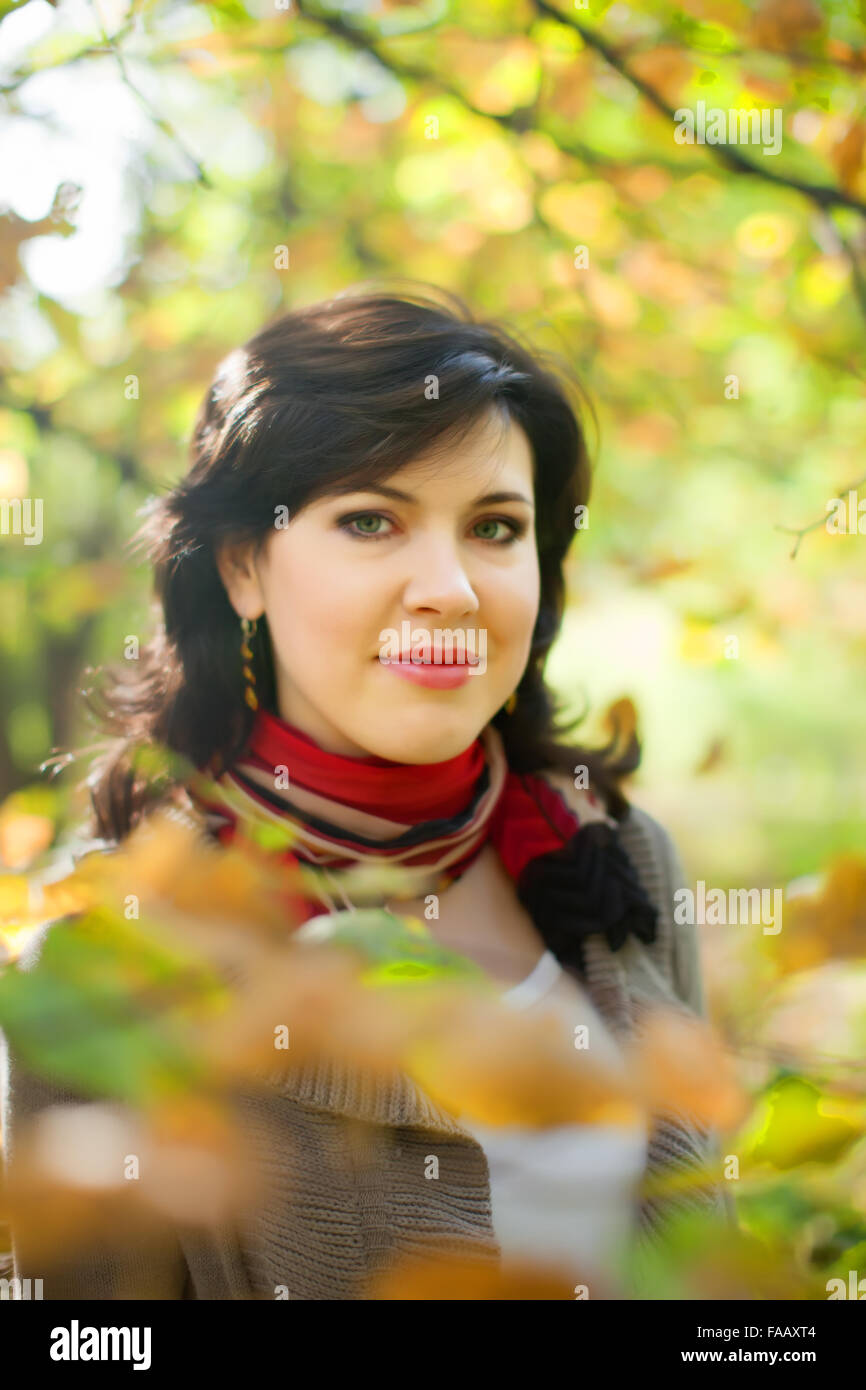Portrait of brunette woman in september park Stock Photo - Alamy