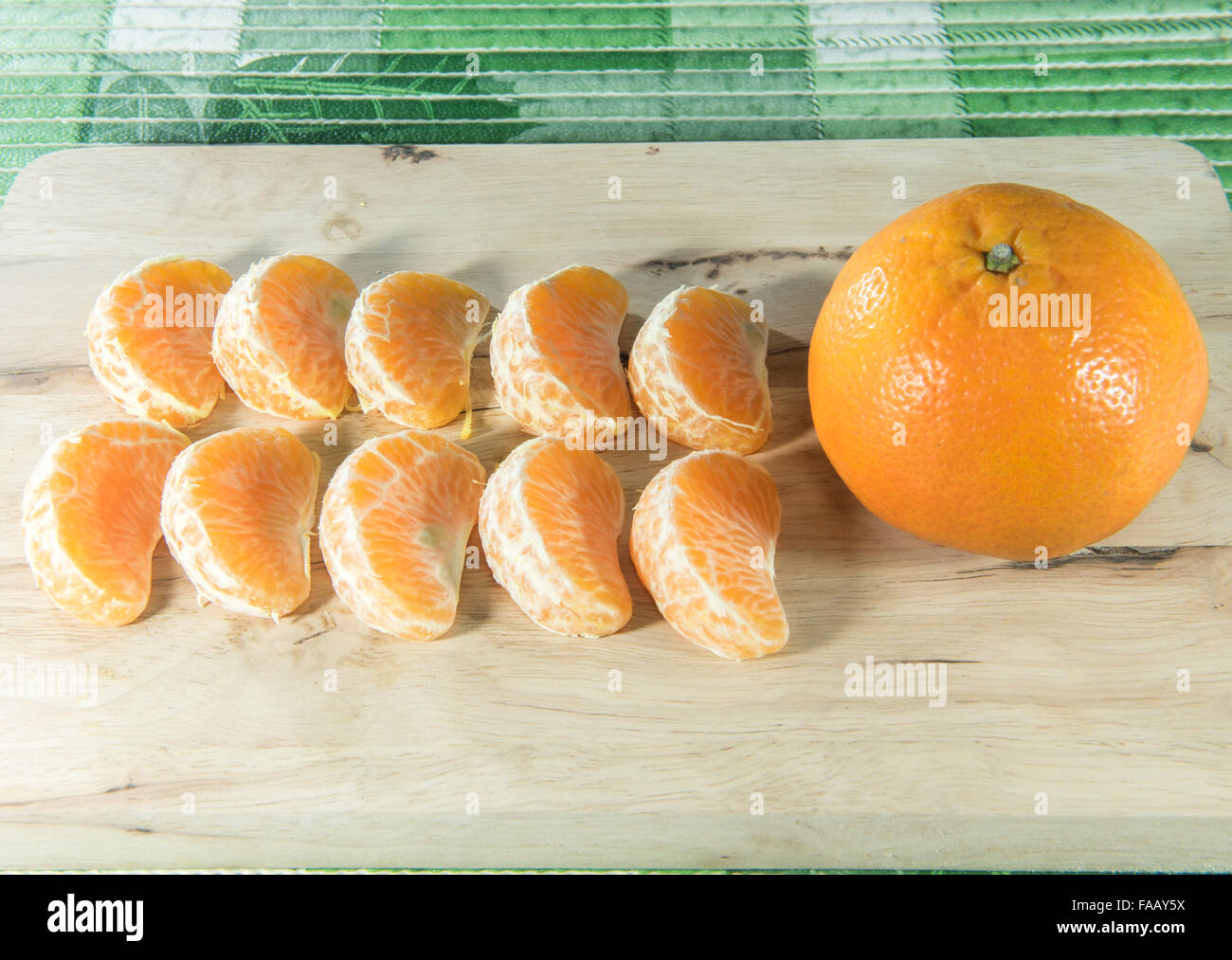 Orange on wooden block Stock Photo - Alamy