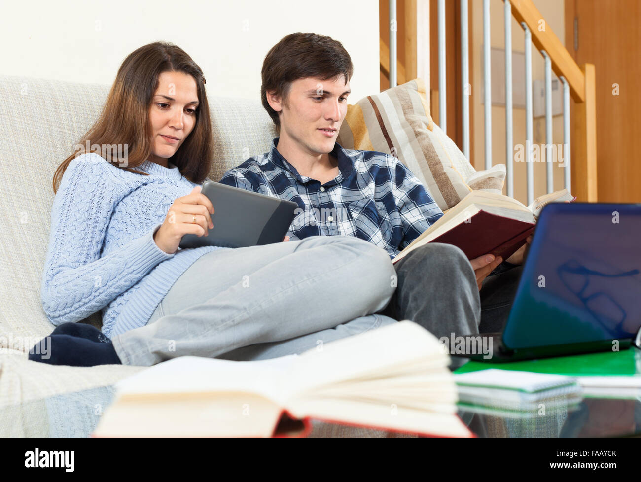 Guy and girl doing homework at table Stock Photo - Alamy