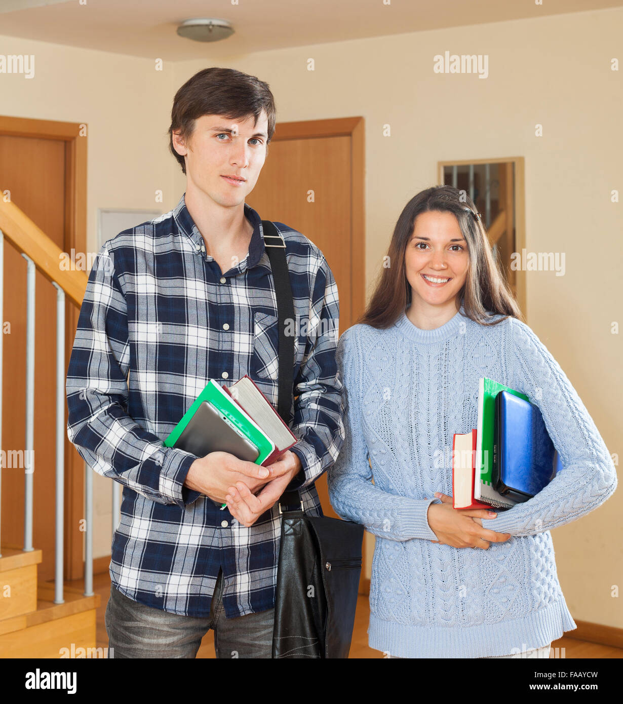 Portrait of smiling students couple at home Stock Photo - Alamy