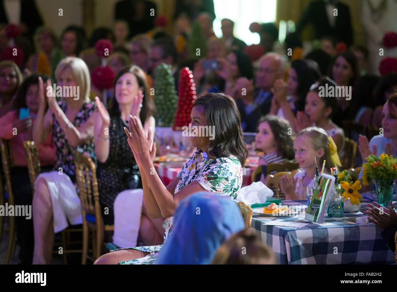 U.S. First Lady Michelle Obama applauds during a performance from the ...