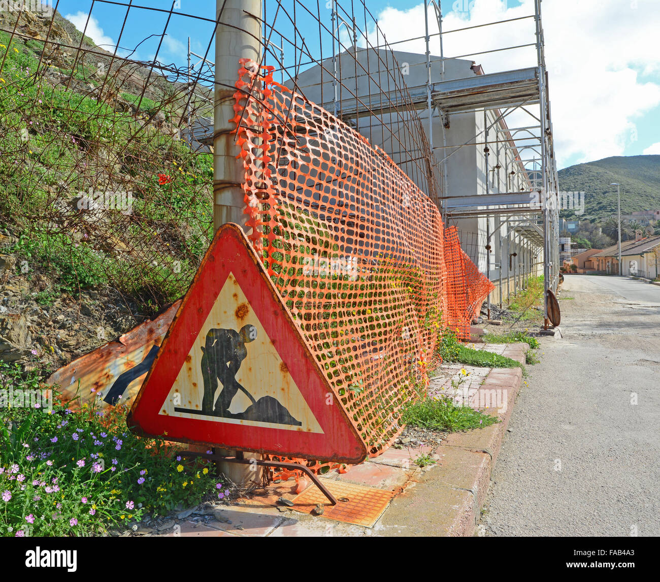 old work in progress sign on the edge of the road Stock Photo - Alamy