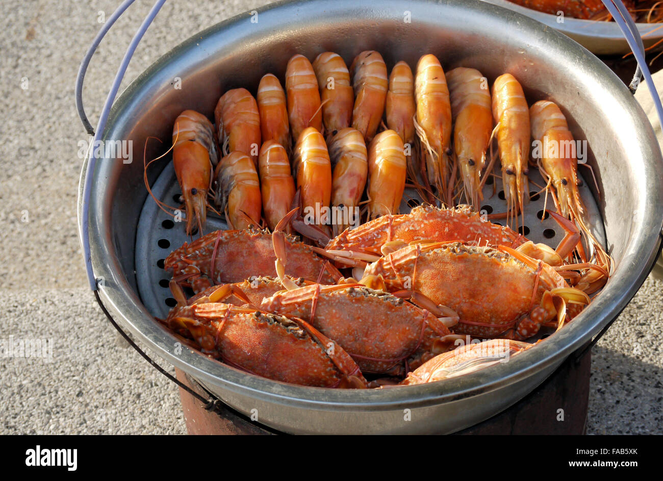 Large King Prawns and Small Crabs being cooked outdoors by a food ...