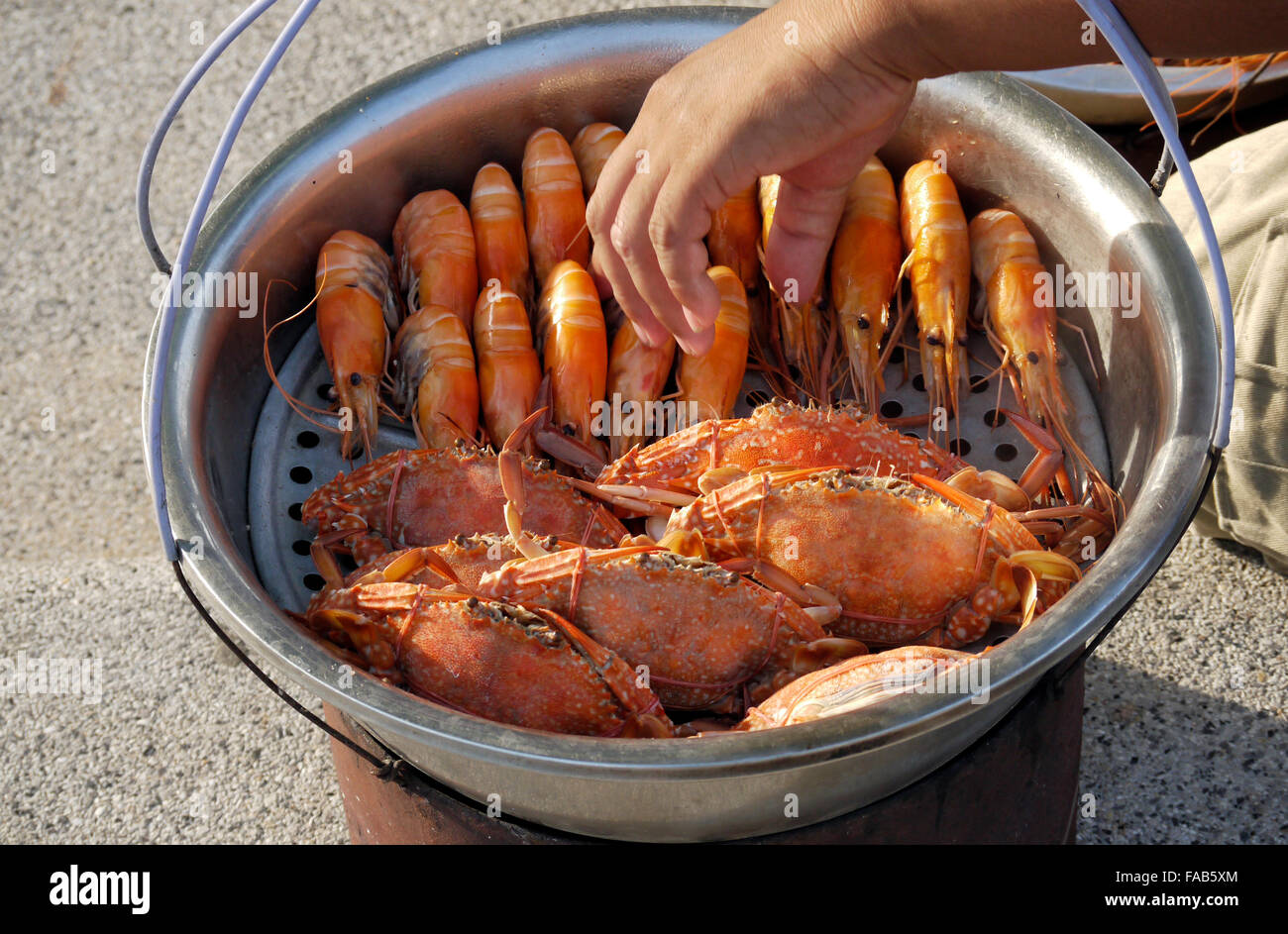 Large King Prawns and Small Crabs being cooked outdoors by a food ...
