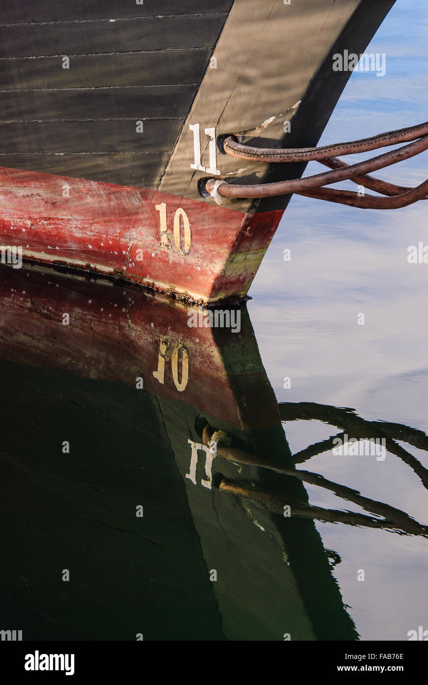 Close-up detail of Schooner bow at the waterline with reflected mirror ...