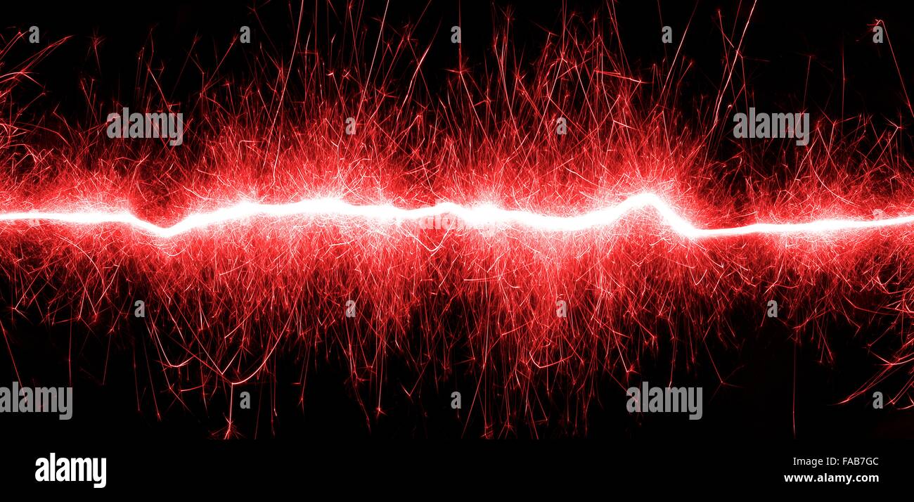 Red sparks against a black background Stock Photo - Alamy