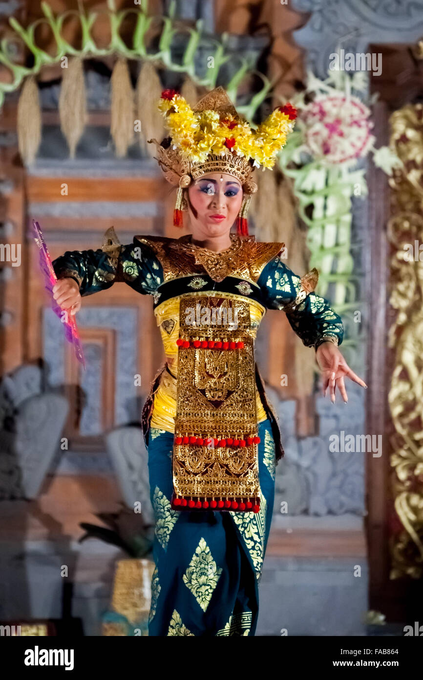 A legong dancer performs on stage during traditional Balinese legong ...