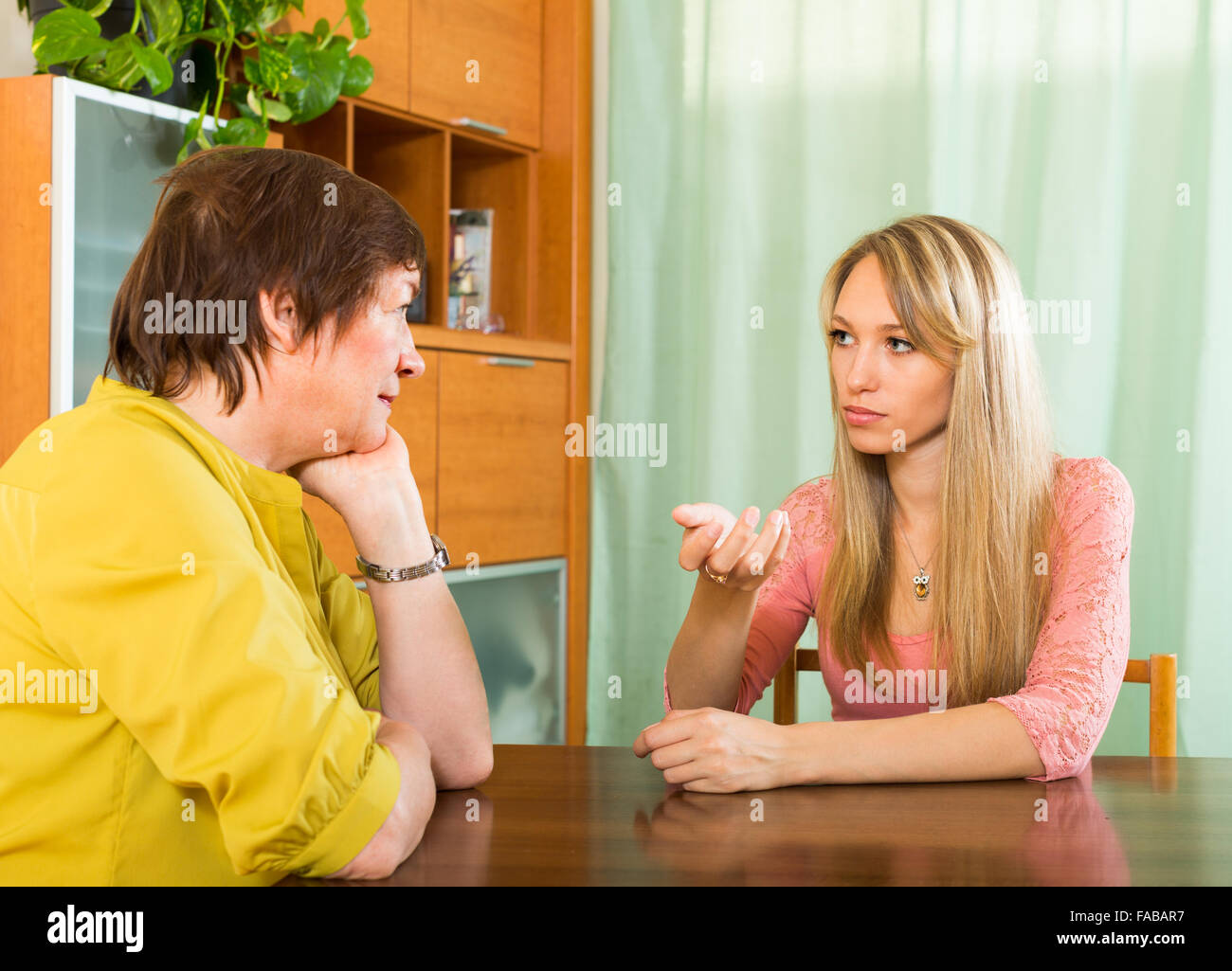 Elderly Mother And Adult Daughter Having Serious Conversation At The