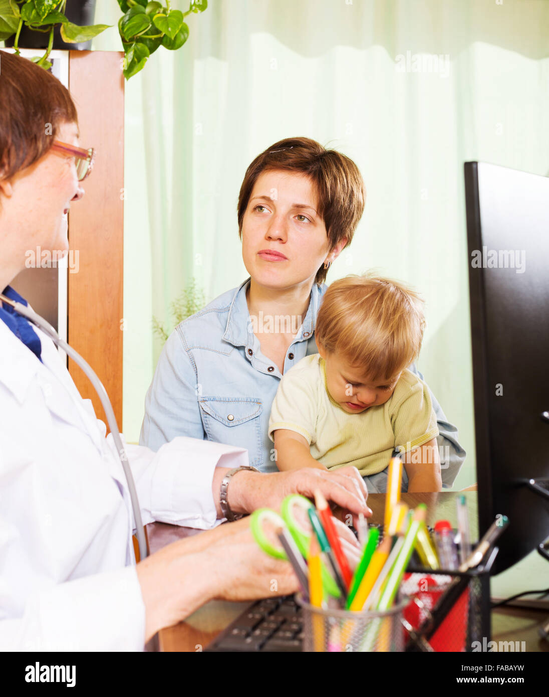 mother with baby listening friendly pediatrician doctor at clinic Stock ...