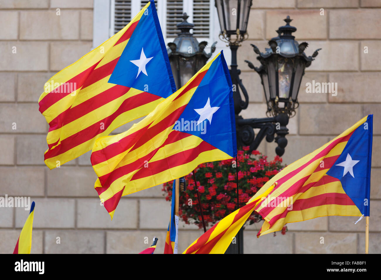 Few flying Catalonia flags with blue estelada in cityspace Stock Photo ...