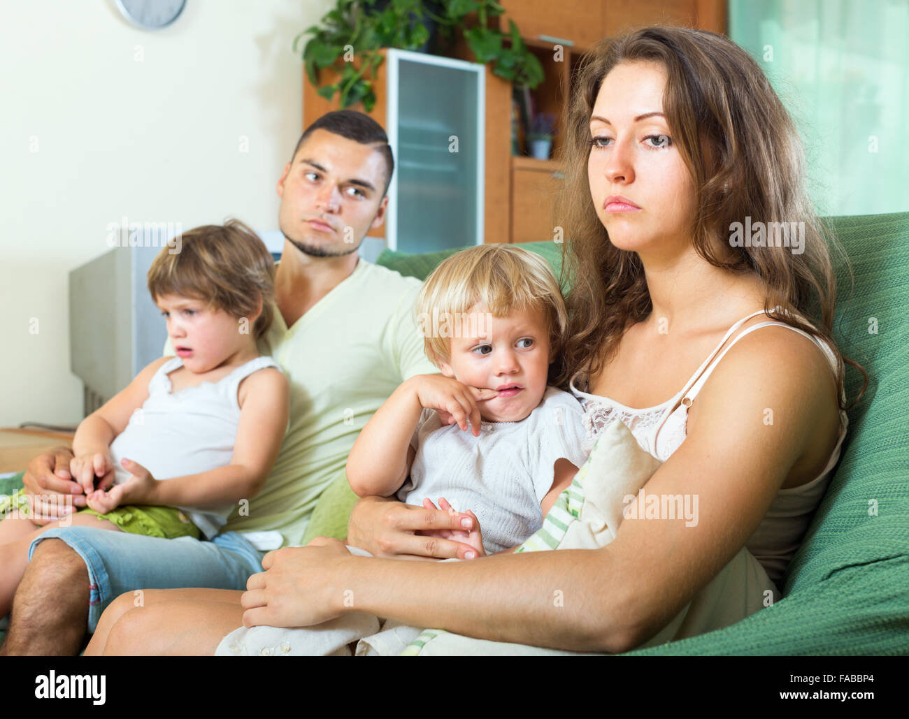 Sad parents of two daughters after quarrel Stock Photo - Alamy