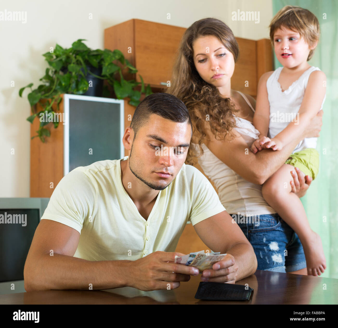 Financial problems in young family with child. Focus on man Stock Photo ...