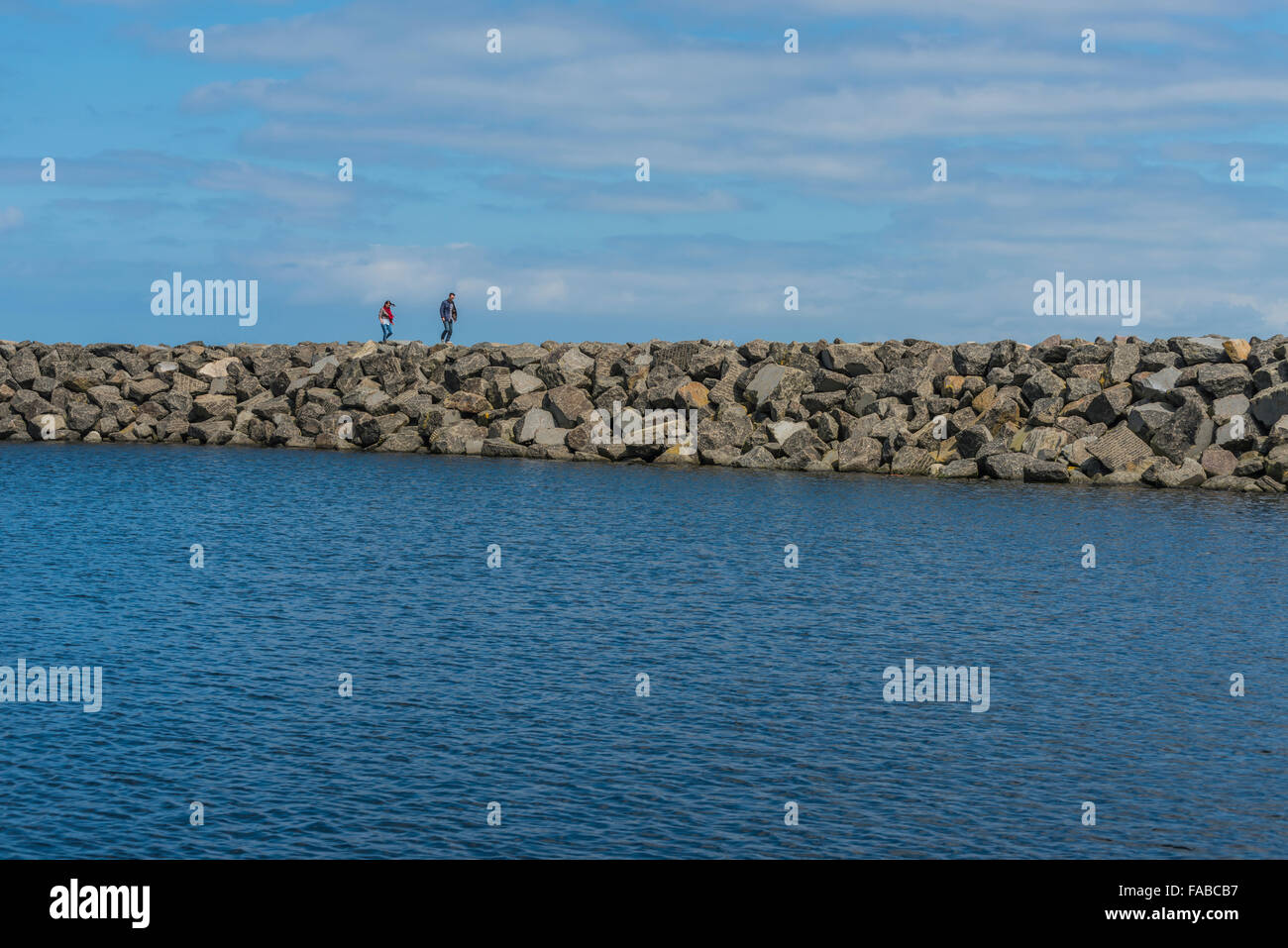 2 persons are standing on a Mole. Male and female at the Baltic sea ...